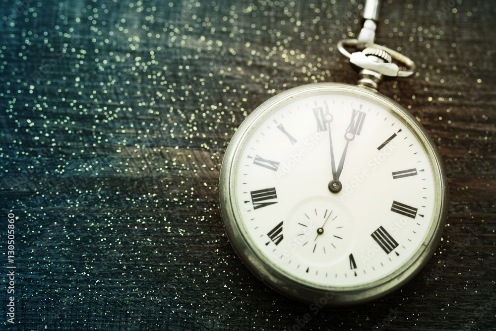 New year clock. Old pocket watch on a wooden background. New Year's ...