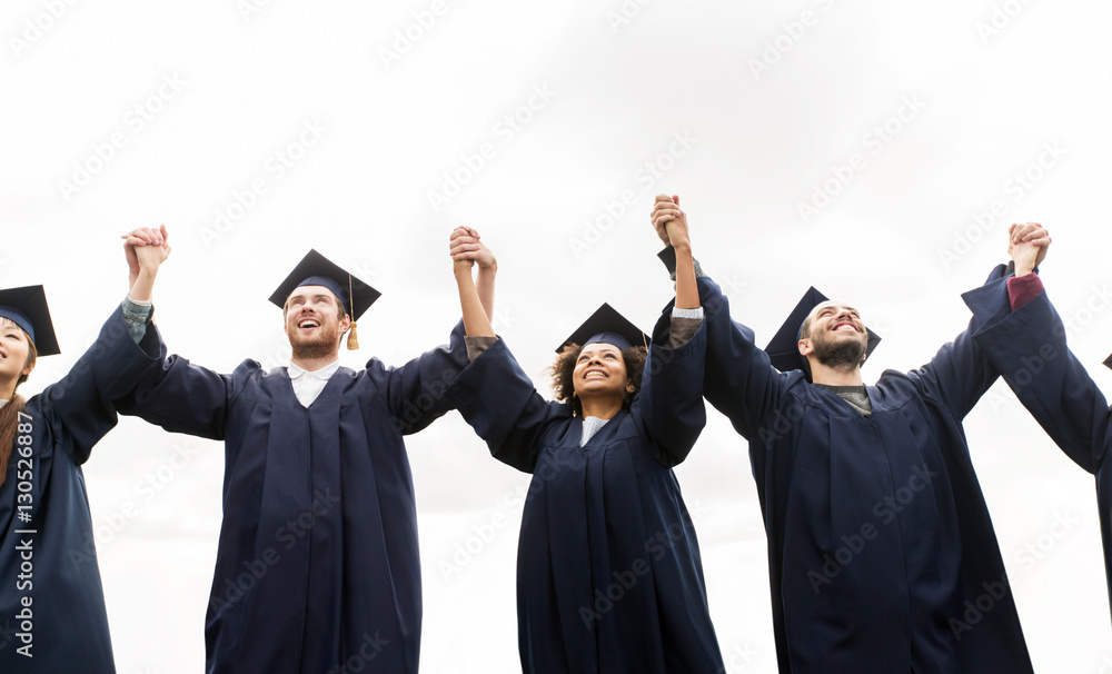 happy students or bachelors celebrating graduation Stock-Foto | Adobe Stock