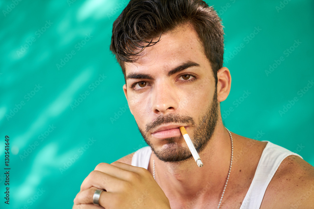 Portrait Of Young Hispanic Man Smoking Cigarette Stock Photo | Adobe Stock