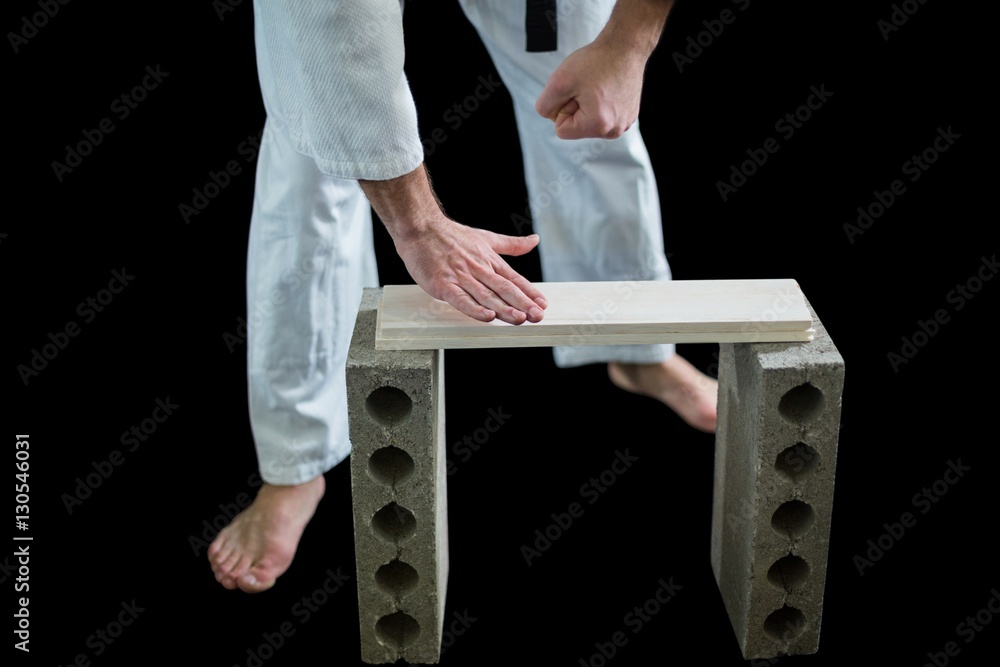 Karate player breaking wooden plank Stock Photo | Adobe Stock