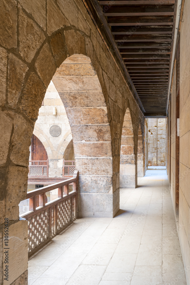 Angled view of one arch with interleaved wooden balustrades at the ...