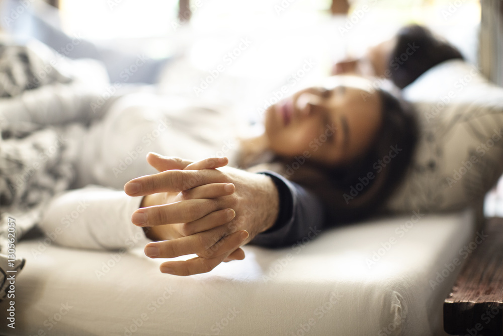 Couple sleeping with holding hands on bed at home Stock Photo | Adobe Stock