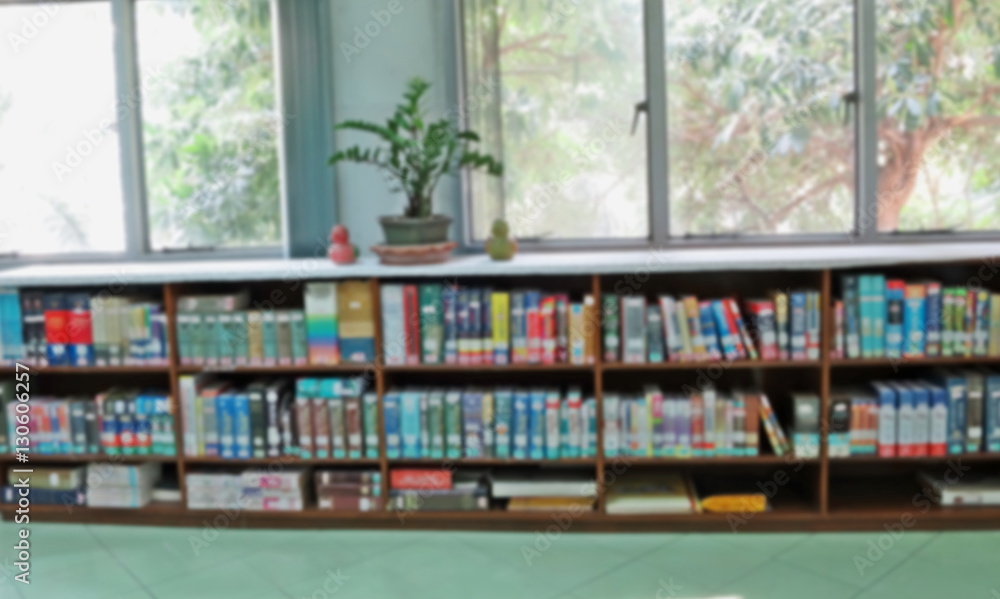 Blurred of interior of old library with bookshelf and big window with ...