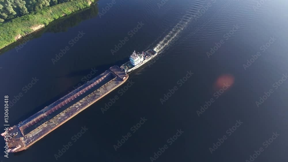 A tugboat and barge floating in the river. Aerial view. Cargo transport ...
