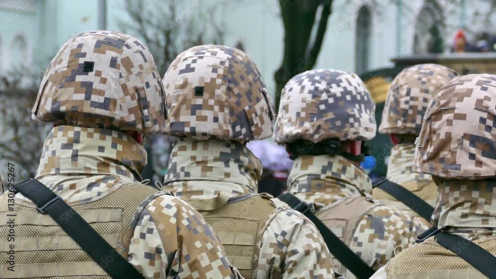 Unrecognizable formation of soldiers from back in army camouflage ...