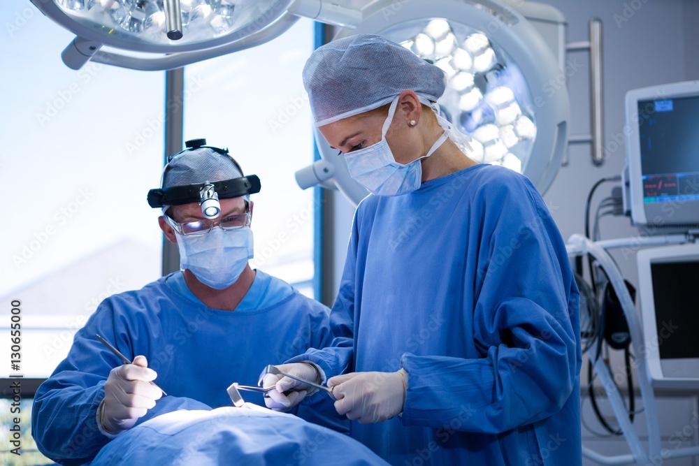 Surgeons performing operation in operation theater Stock Photo | Adobe ...