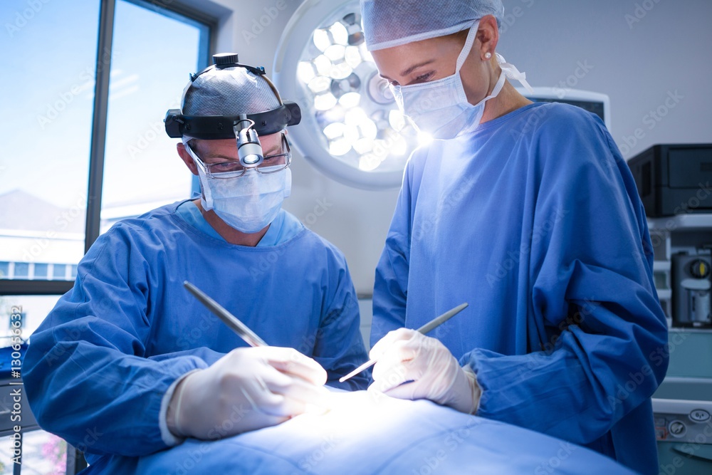 Surgeons performing operation in operation theater Stock Photo | Adobe ...