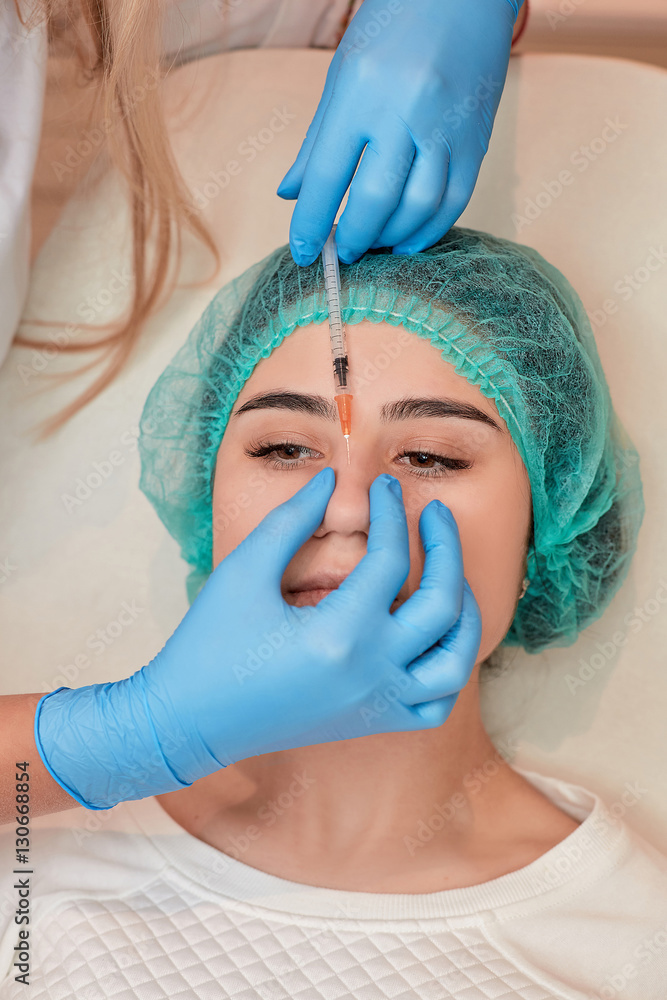 Closeup of woman receiving cosmetic injection through nose. Stock Photo ...
