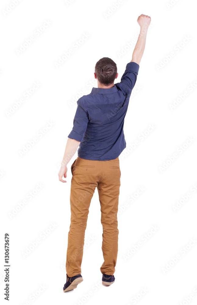 Back view of man in checkered shirt Raised his fist up in victory sign ...