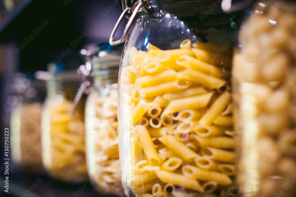 pasta in the jar. on kitchen shelves are different kinds of pasta in ...