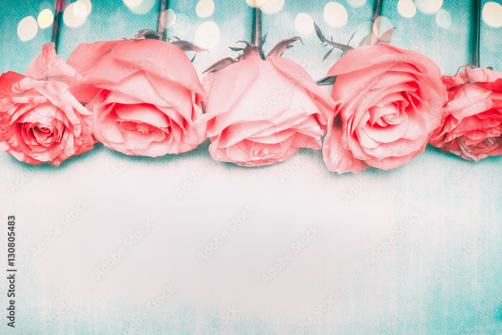 Beautiful romantic roses border on blue background with bokeh in pastel ...