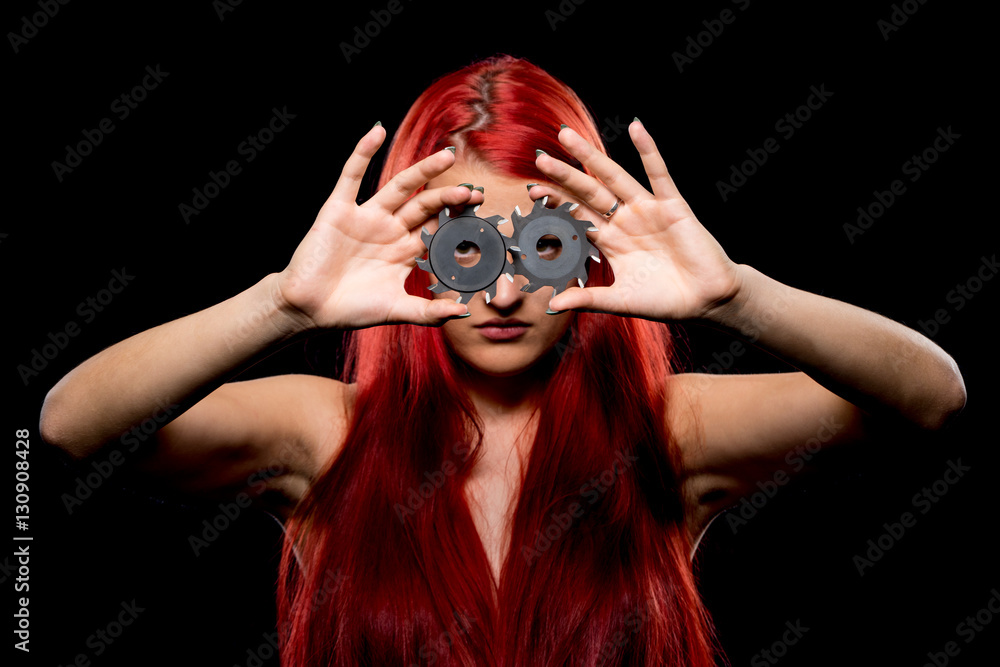 Portrait of beautiful girl with circular saw blade. Bretty naked woman ...