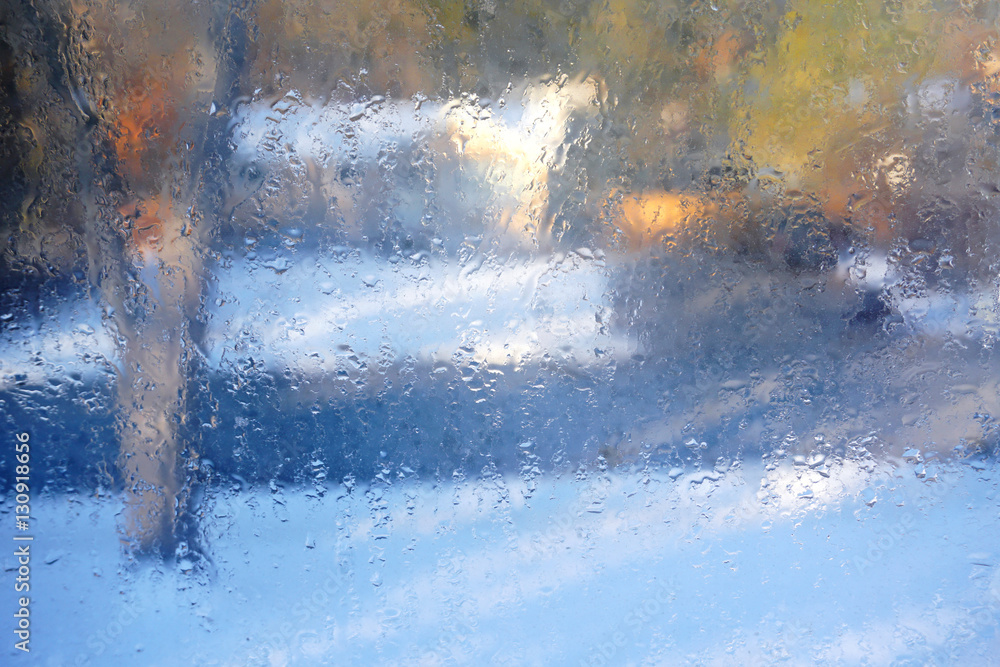 glass window with rain drop and outside winter residential scenery ...