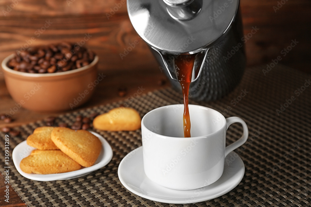 Fresh coffee pouring from pot into cup Stock-Foto | Adobe Stock