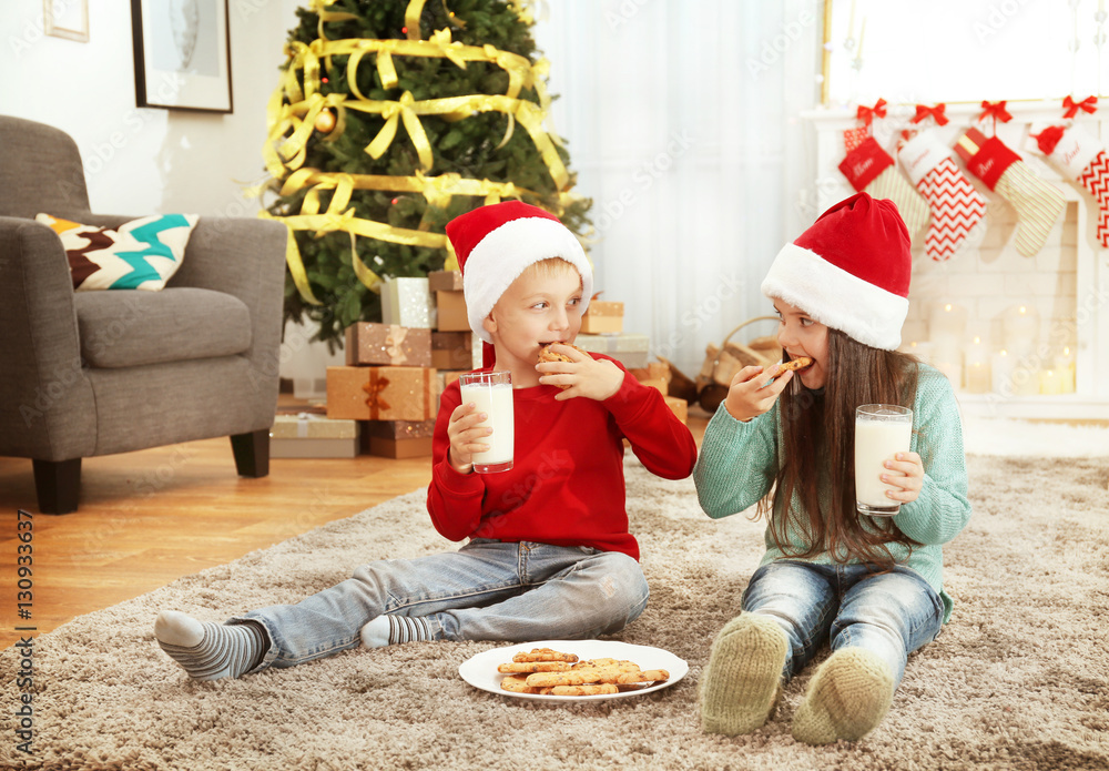 Cute little kids in Santa hats drinking milk and eating delicious ...