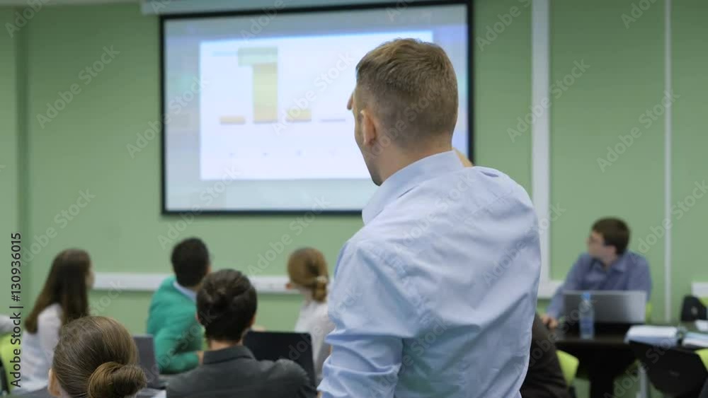 Professional teacher in class room at the university is delivering ...