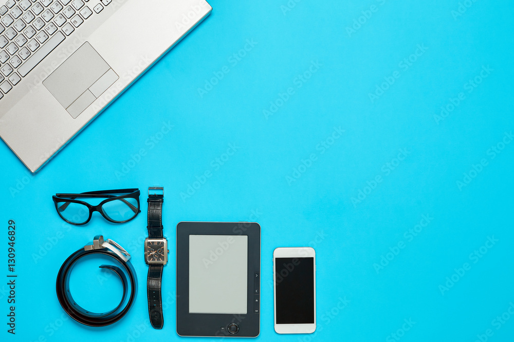 Image of blue Office Desk with laptop Keyboard, phone, watch, ebook ...