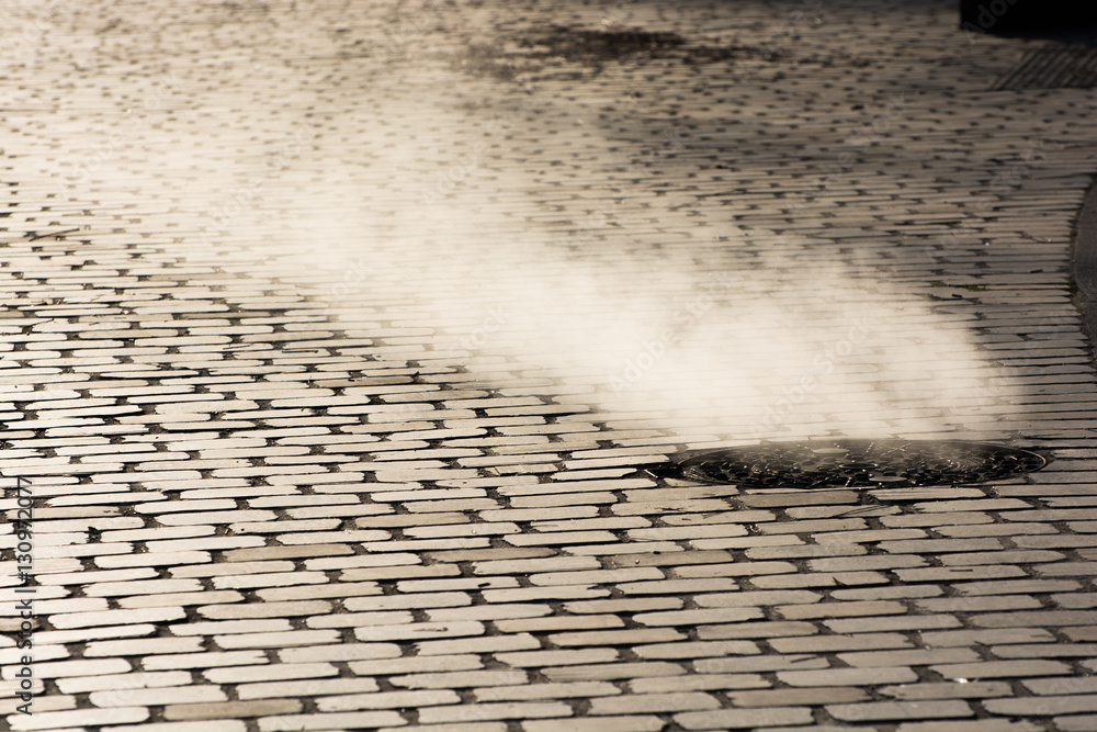 Steam coming out of manhole in a street of Paris Stock Photo | Adobe Stock