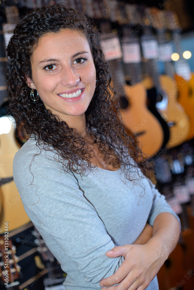 Portrait of woman in musical instrument shop Stock-Foto | Adobe Stock