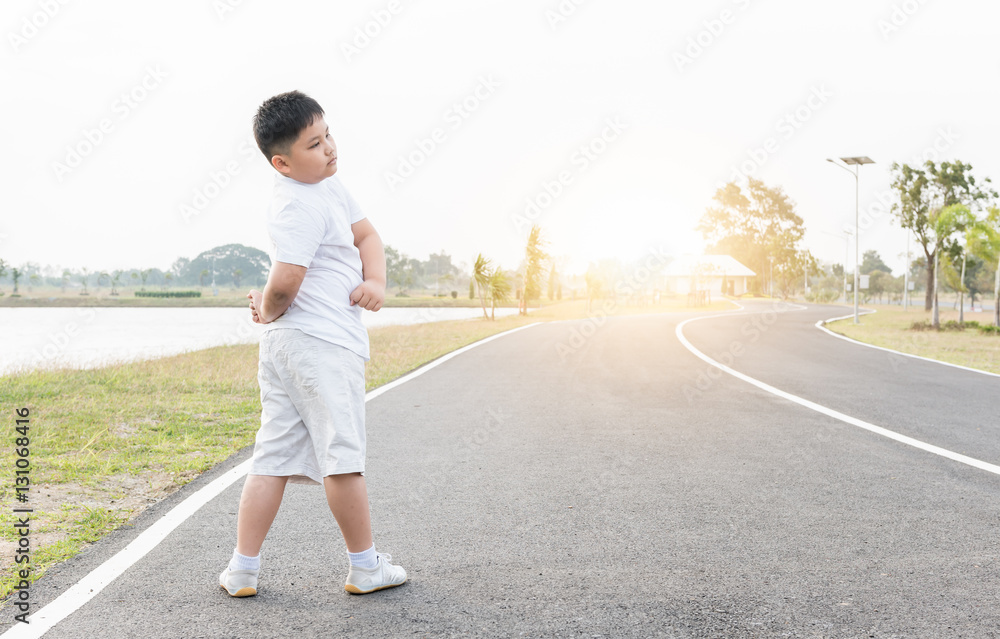 Obese fat boy exercise at park on morning Stock Photo | Adobe Stock