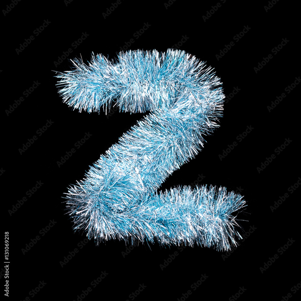 Festive alphabet made of blue tinsel. Letter Z on black background ...