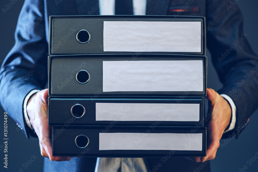 Businessman with corporate files in four document binder Stock Photo ...