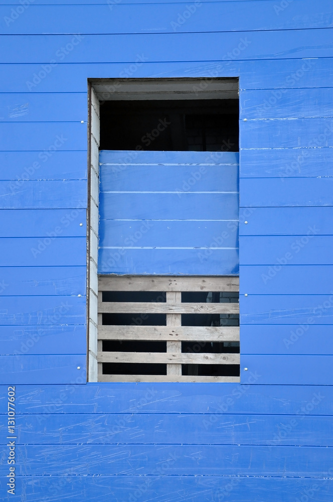 The front facade of a modern building of blue horizontal panels with a ...