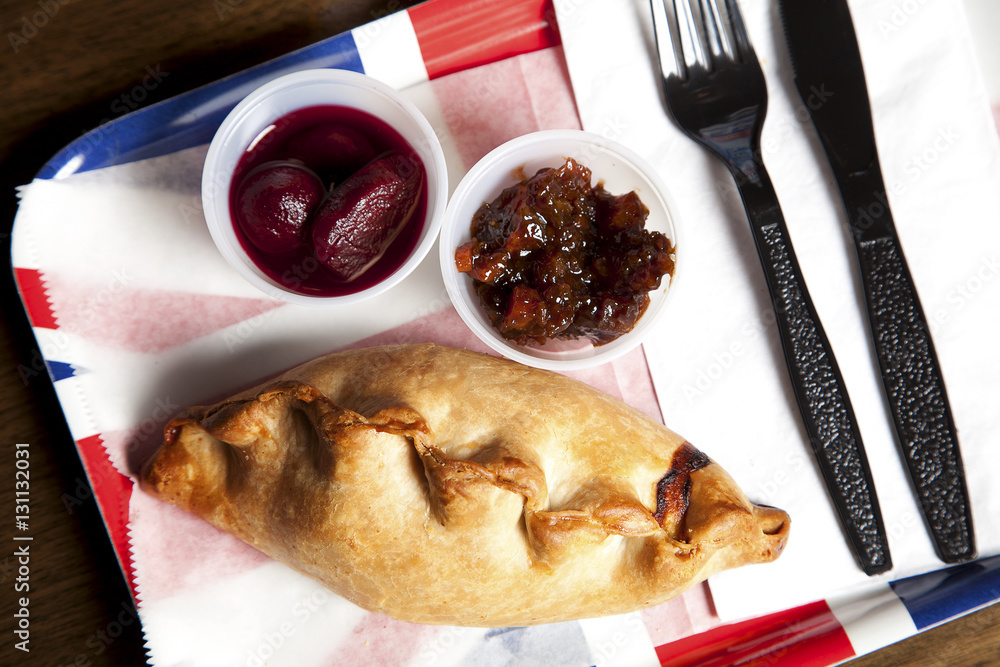 Cornish pasty with pickles on Union Jack tray Stock Photo | Adobe Stock