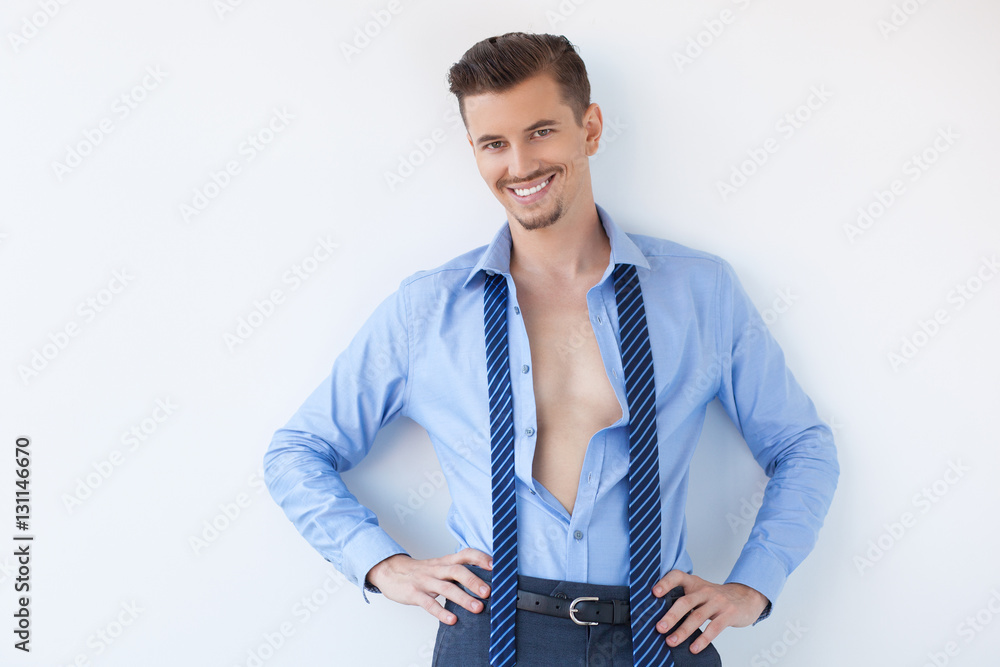 Smiling Young Business Man in Unbuttoned Shirt Stock Photo | Adobe Stock