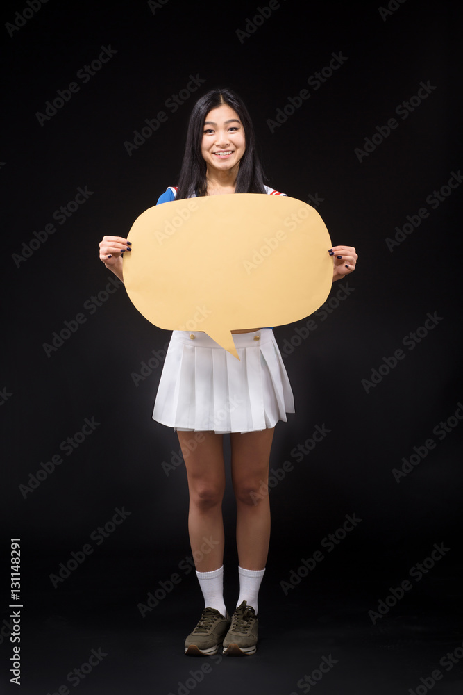 Happy Asian woman posing in full length and holding blank poster for ...