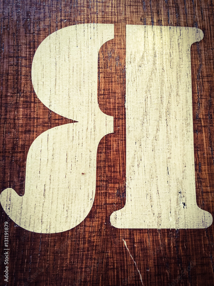 Wooden alphabet letter R, mirrored back. Written letter with paint on a ...