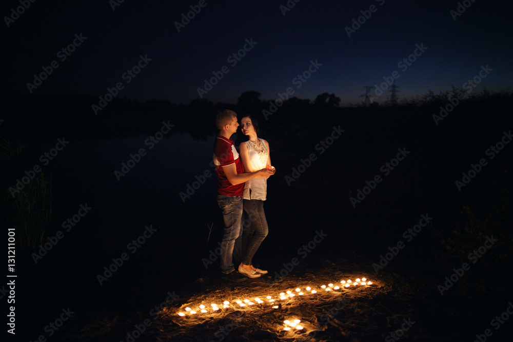 Evening candlelight lakeside wine beautiful couple in love. Romantic ...