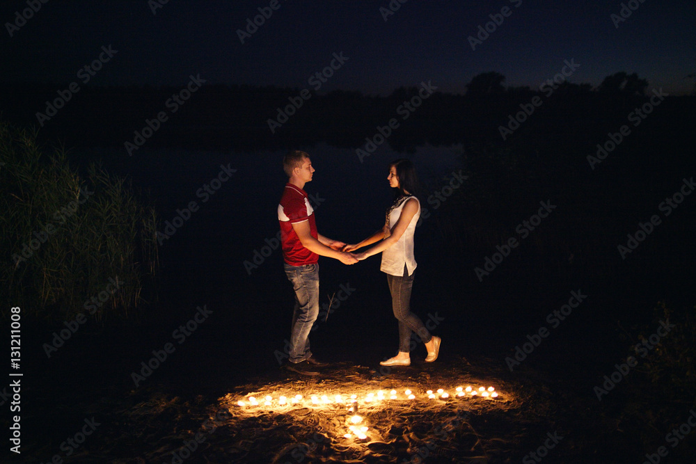 Evening candlelight lakeside wine beautiful couple in love. Romantic ...