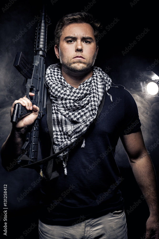 Soldier or mercenary wearing a shemagh with assault rifle, paintball or ...