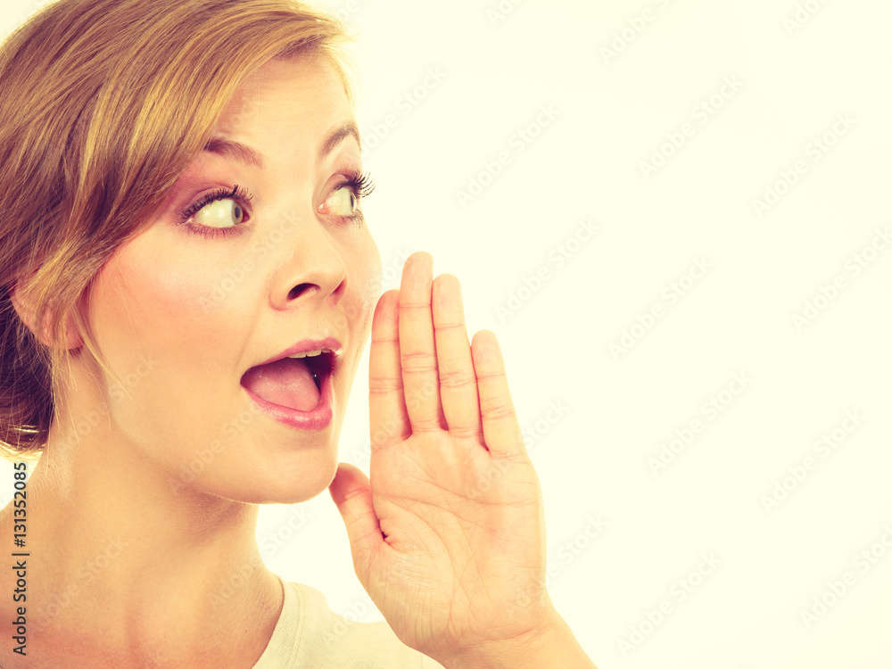 Woman whispering with hand close to mouth Stock Photo | Adobe Stock