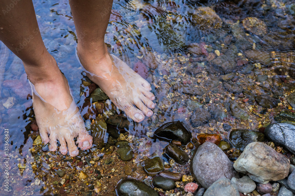 Feet soak in water stream Stock Photo | Adobe Stock