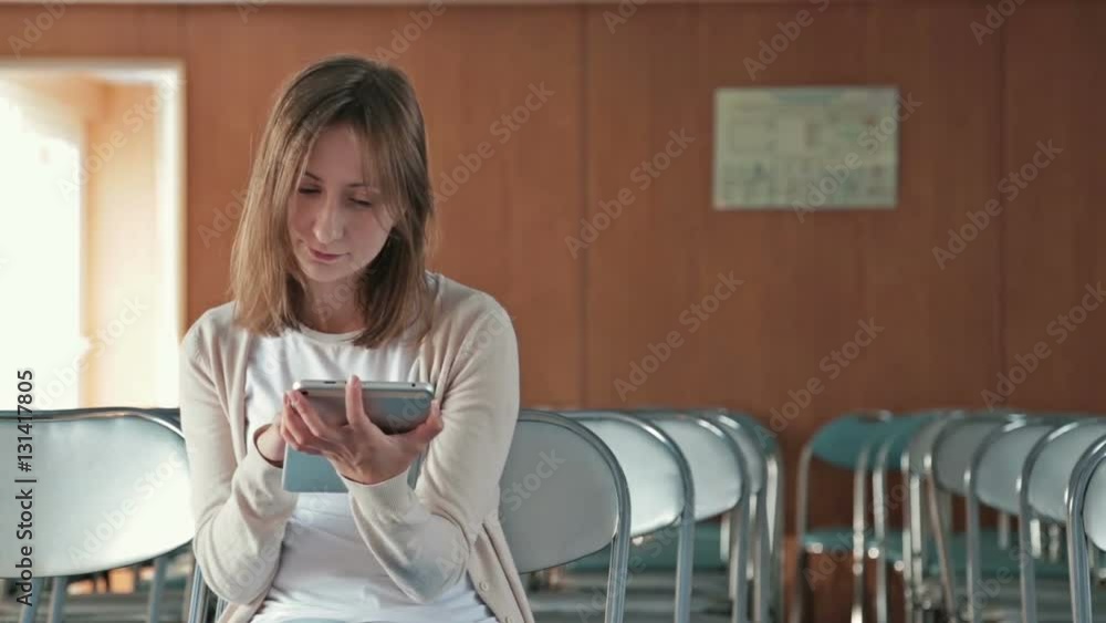 An attractive caucasian woman uses her new digital PC tablet with ...