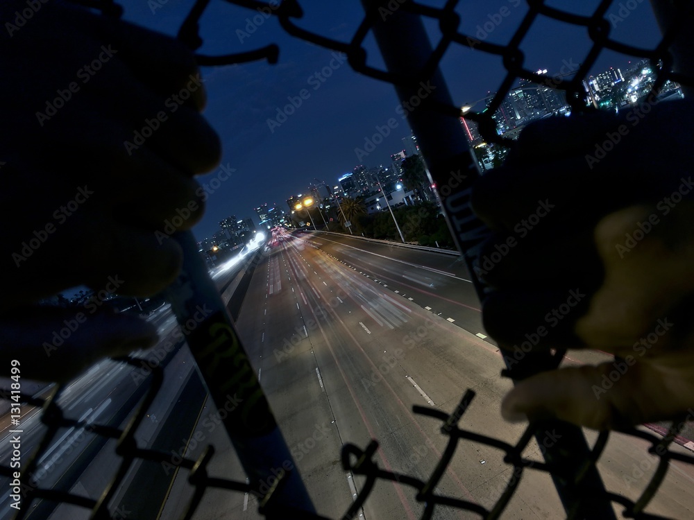 Urban landscape of city skyline and freeway through an opening of a ...
