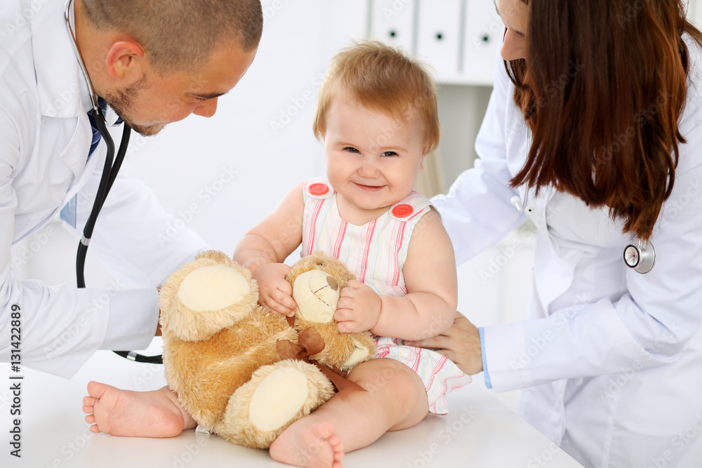 Happy cute baby at health exam at doctor's office. Medicine and health ...