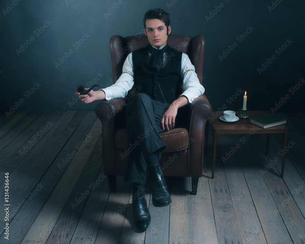 Retro victorian man sitting in leather chair holding pipe. Stock Photo ...