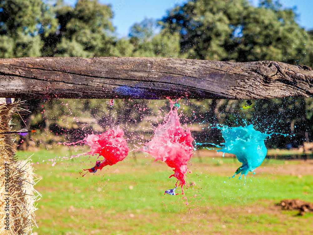 Balloons exploding when hit by an arrow. Closeup hi-speed shot Stock ...