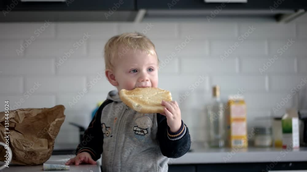 Little Funny Boy Eating Bread With Happy Face Stock Video | Adobe Stock