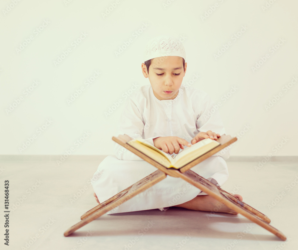 Happy kids reading Koran Stock Photo | Adobe Stock