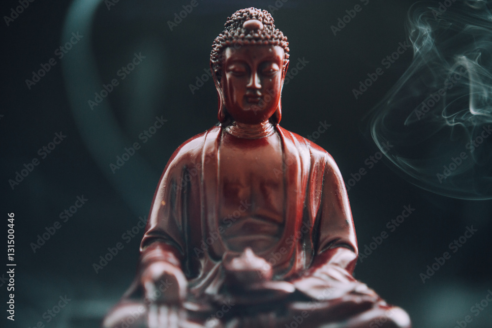 Buddha statue with incense. Deity and symbols of Buddhism. The practice ...