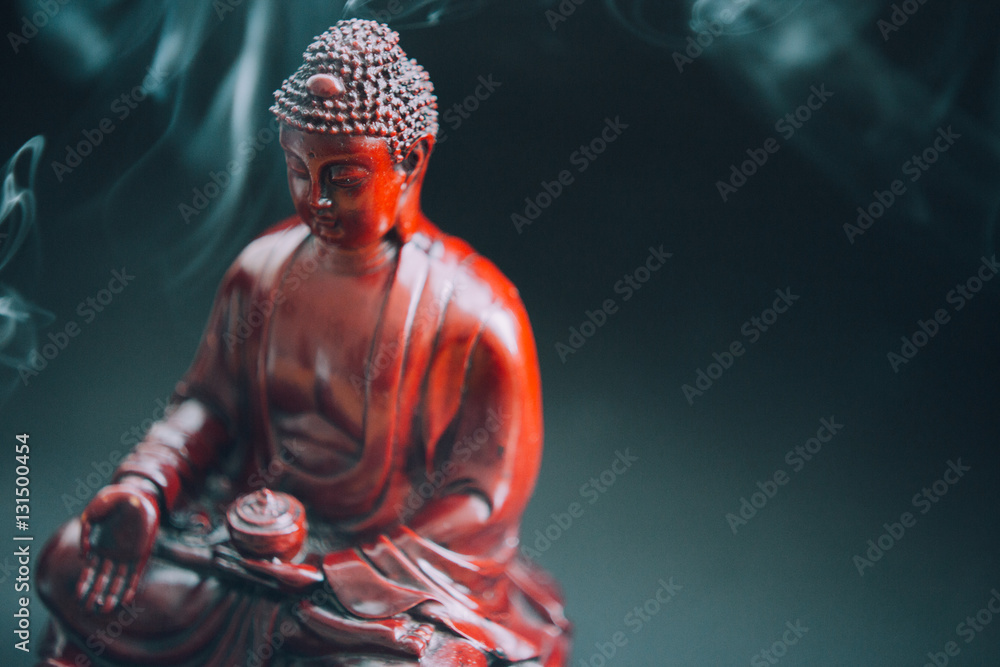 Buddha statue with incense. Deity and symbols of Buddhism. The practice ...