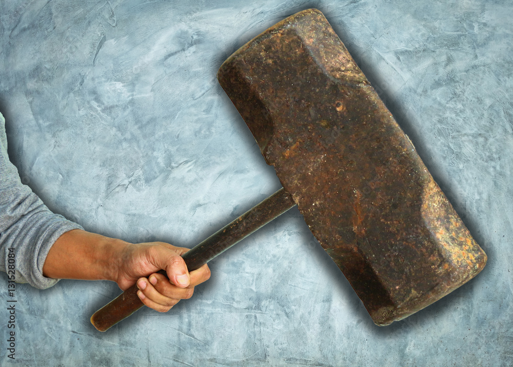 Aggressive human hand holding hammer on concrete background Stock Photo ...