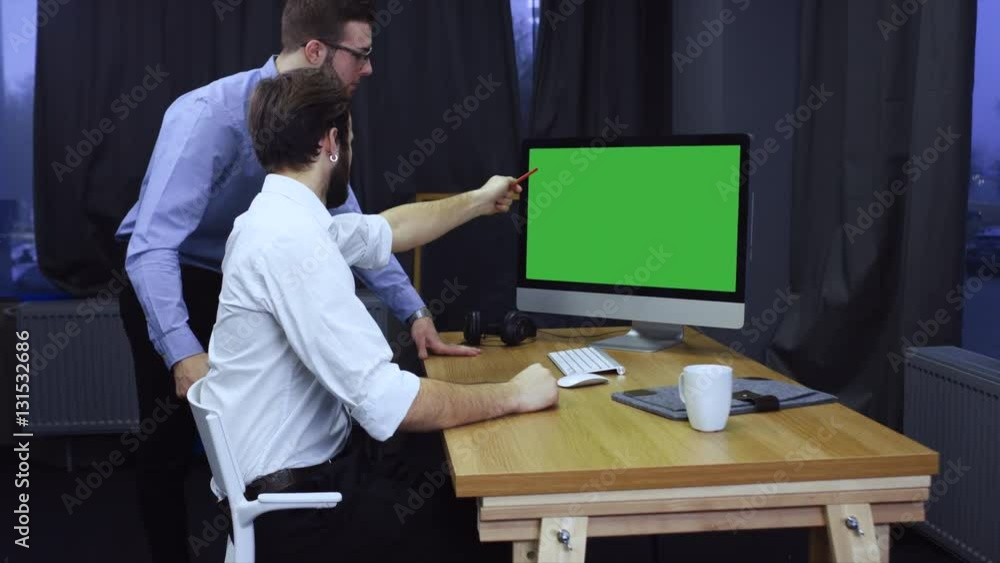 Two developers working on a project at trendy start up office ...