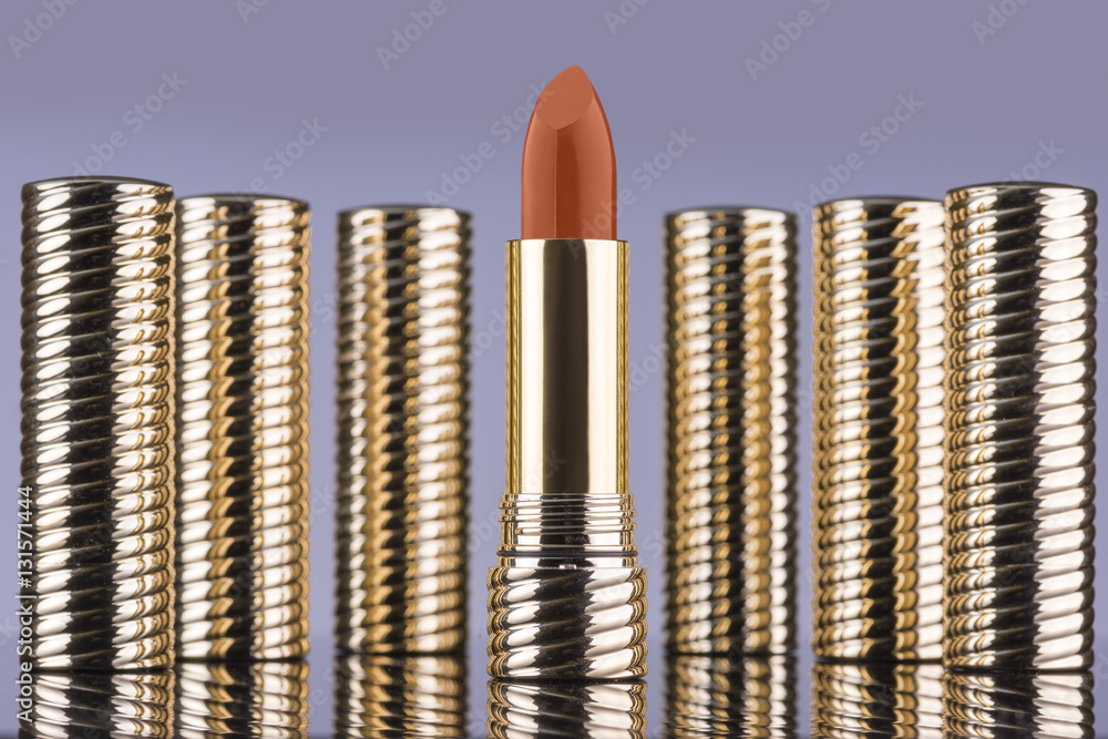 Pale red color lipstick sample in a sharp golden tube, with other six ...