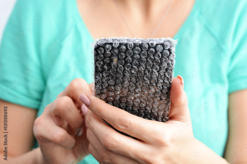 Smartphone protection concept with mobile device wrapped in air foil ...