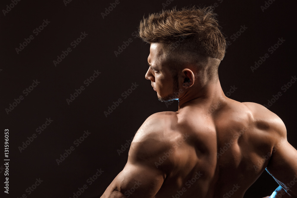 Strong Athletic Man Fitness Model posing back muscles, triceps ...